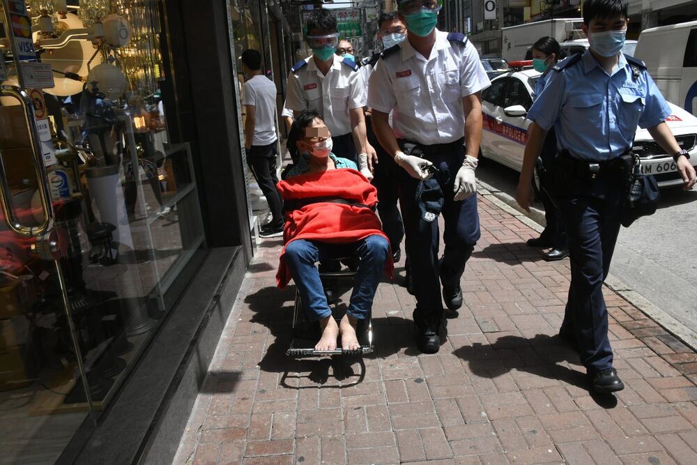 Man being restrained by several men, two nabbed