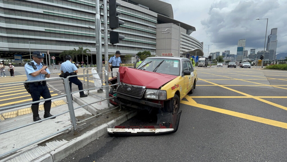 Four injured after taxi crashes into metal fence