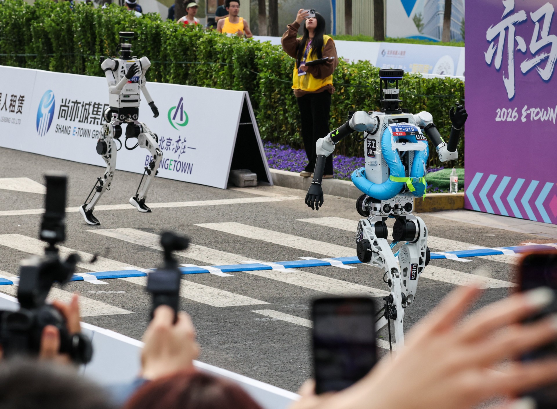 Humanoid robots race past humans in Beijing half-marathon, showing ...
